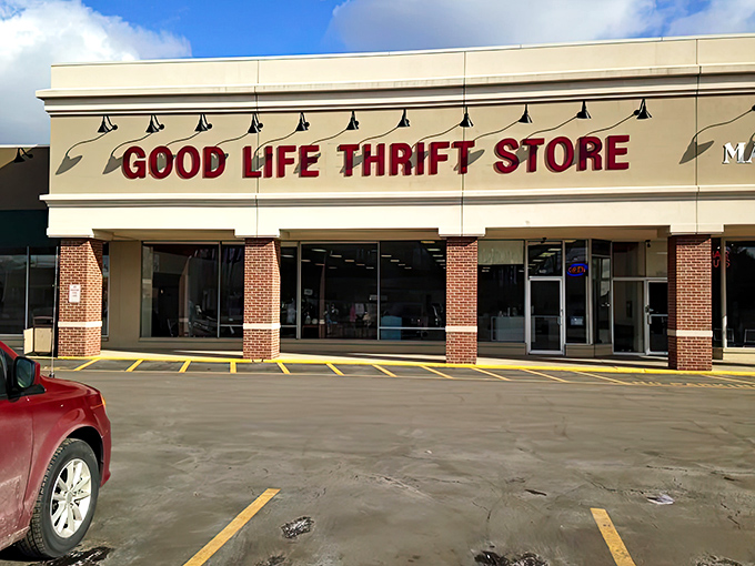 The storefront beckons like a siren song to bargain hunters. Bold red letters promise treasures within those brick-framed doors.