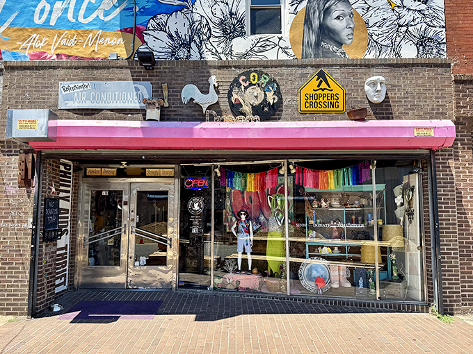 A colorful storefront that screams "treasures inside!" with its vibrant rainbow display and eclectic window decorations.