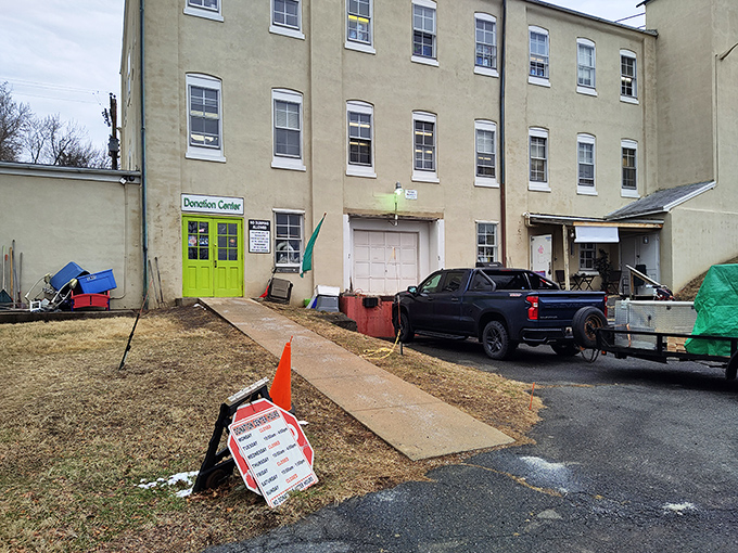 The donation center's bright green door serves as a portal where yesterday's belongings begin their journey toward becoming tomorrow's discoveries.