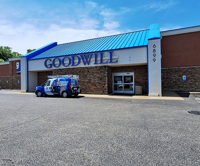The iconic blue roof of Goodwill on Stage Road beckons like a retail lighthouse, guiding bargain hunters to shores of unexpected treasures.
