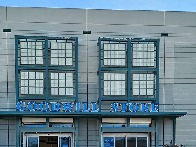 The Goodwill Store on Westmoreland stands like a beacon of bargain possibilities under the bright Texas sky, promising treasures within its unassuming exterior.