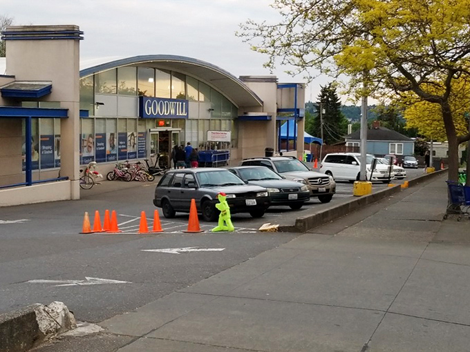The blue Goodwill sign beckons like a lighthouse for bargain hunters, with shopping carts standing ready for treasure-seeking missions.