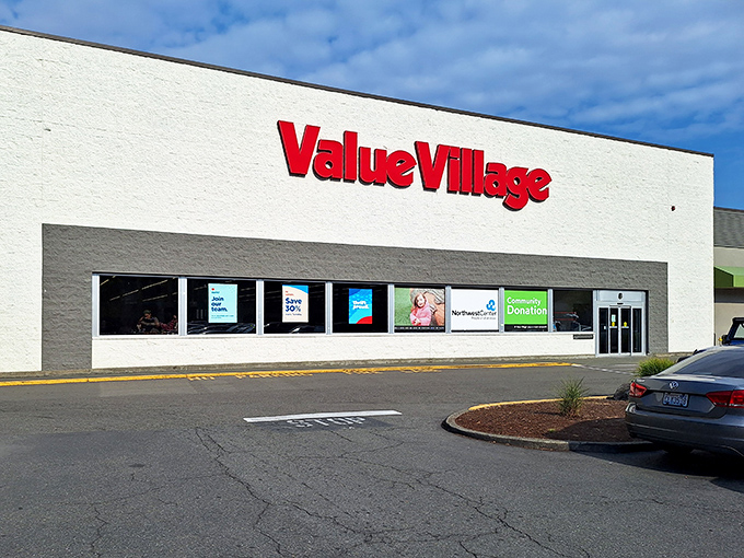 The iconic red Value Village sign beckons treasure hunters like a retail lighthouse guiding ships full of bargain-seekers to safe harbor.