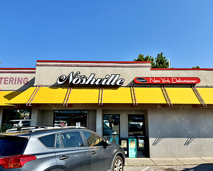 The bright yellow awning of Noshville beckons like a culinary lighthouse, promising authentic New York deli flavors in the heart of Nashville.