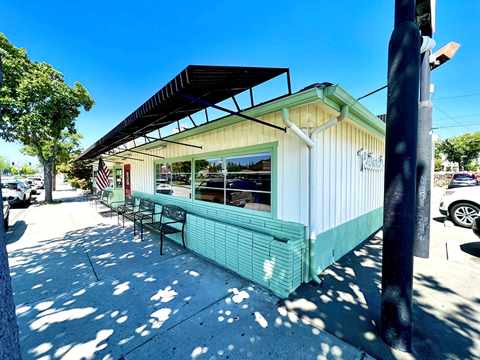 The bright red door isn't just an entrance &ndash; it's a portal to breakfast paradise, complete with mint-green benches for contemplating pancake possibilities.