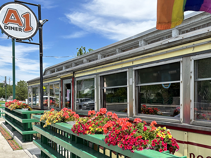 Flower boxes burst with color along the diner's chrome exterior, nature's way of saying "the food inside is just as vibrant as these petunias."