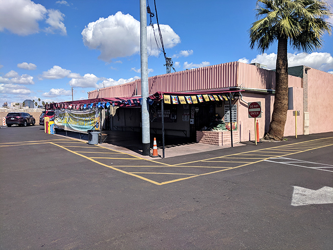 Another view reveals the restaurant's pink facade and striped awning&mdash;architectural appetizers before the main course of flavors waiting inside.
