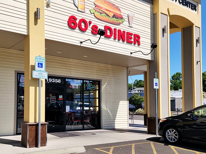 The bright red "60's DINER" sign beckons like a time machine, promising comfort food and nostalgia in equal measure.