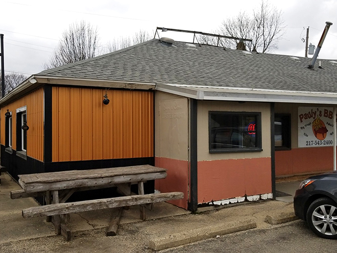 Small in stature but mighty in flavor, Pauly's exterior features rustic wooden benches where BBQ dreams begin.