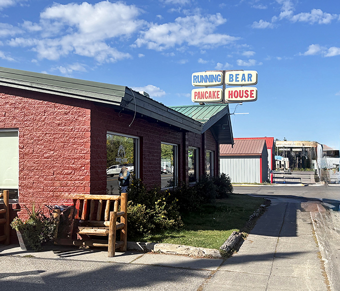 The classic red-brick exterior of Running Bear Pancake House stands as a beacon of breakfast hope for hungry Yellowstone visitors and locals alike.