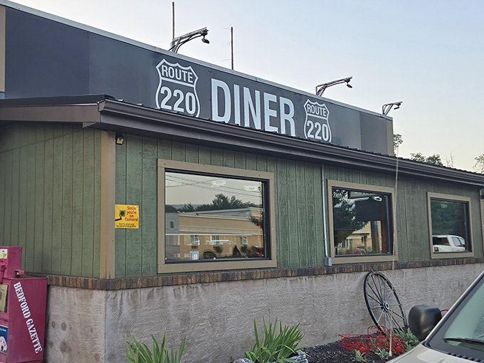 The unassuming exterior of Route 220 Diner stands like a culinary sentinel along the highway, promising comfort and nostalgia to weary travelers.