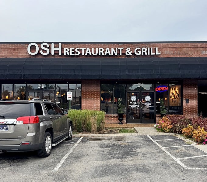 The unassuming brick exterior of OSH Restaurant & Grill might not scream "culinary adventure," but that red neon "OPEN" sign is your portal to Uzbekistan in Nashville.