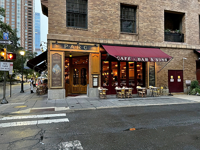 The iconic corner entrance of Parc, where Philly meets Paris. Those yellow awnings and rattan chairs aren't just decoration&mdash;they're time machines to the Champs-&Eacute;lys&eacute;es.