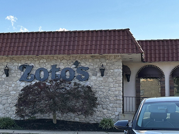 The stone facade and burgundy roof of Zoto's Diner stands like a culinary lighthouse in Line Lexington, beckoning hungry travelers with promises of comfort food paradise.