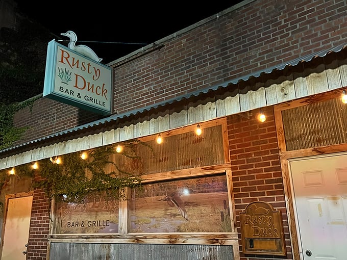 The Rusty Duck announces itself with rustic charm and twinkling lights that promise good times ahead on Main Street.