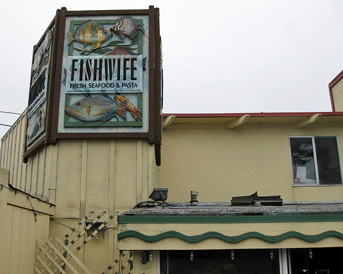 The iconic Fishwife sign stands proud against the Pacific Grove sky, promising seafood treasures within its humble walls.