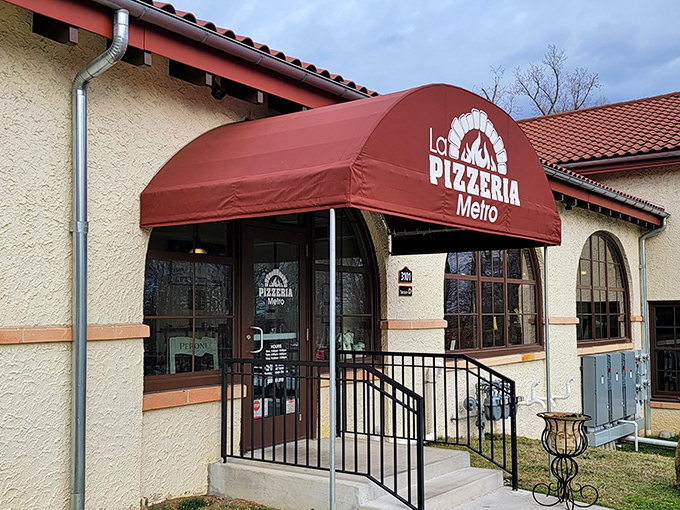 The unassuming exterior of La Pizzeria Metro, where that iconic red awning serves as a beacon for pizza pilgrims throughout Delaware.