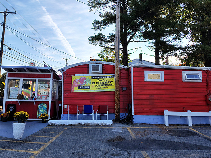 Where nostalgia meets appetite &ndash; the Brunswick Diner's vibrant red siding and colorful outdoor seating area create the perfect backdrop for Maine morning magic.