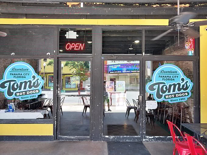 The iconic blue signage of Tom's Hot Dogs beckons hungry travelers like a lighthouse for the famished. Downtown Panama City's worst-kept culinary secret since 1981.