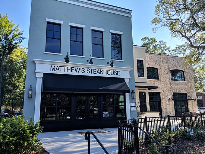 Matthew's Steakhouse stands proudly in Winter Garden, its elegant blue exterior and classic black awning promising culinary adventures within the charming historic downtown.