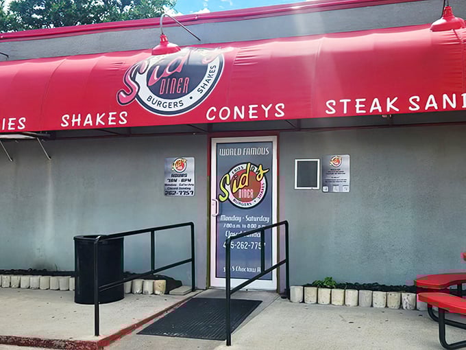 The bright red awning of Sid's Diner beckons like a culinary lighthouse on Route 66, promising comfort food that's worth every mile of the journey.