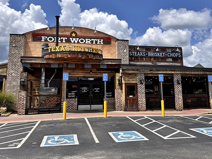 The Fort Worth Steakhouse exterior stands proud against Tennessee skies, promising carnivorous delights with its no-nonsense signage and rustic brick charm.