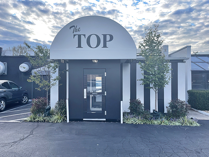 The iconic white marquee of The Top Steak House beckons like a culinary lighthouse, promising refuge from mediocre meals in a sea of chain restaurants.