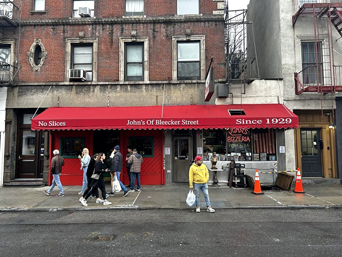 The iconic red awning of John's proudly declares "No Slices" &ndash; a battle cry that separates the pizza tourists from the true believers.