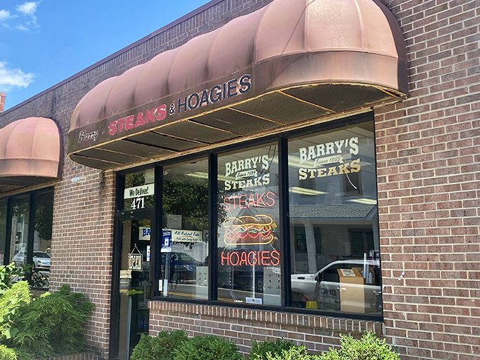 Those burgundy awnings aren't just decoration &ndash; they're a beacon calling hungry souls to cheesesteak salvation in Roxborough.