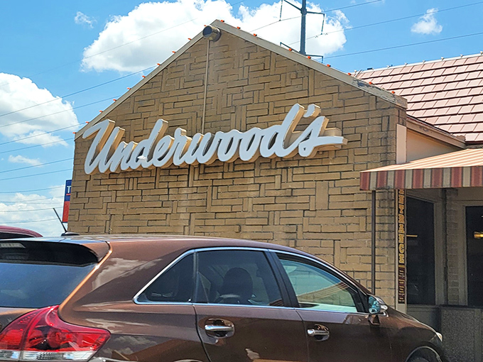 The iconic cursive "Underwood's" sign welcomes hungry pilgrims like a beacon of barbecue hope in the Texas landscape.