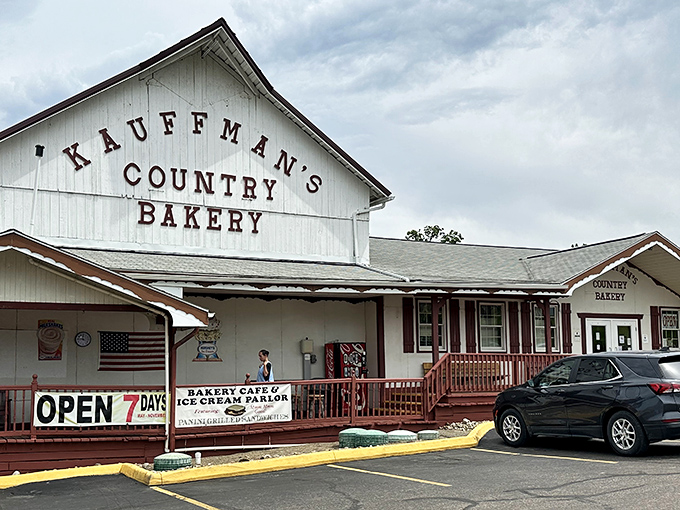 The classic white façade of Kauffman's Country Bakery stands like a beacon of carb-laden hope in Amish Country, complete with charming red railings and welcoming porch.