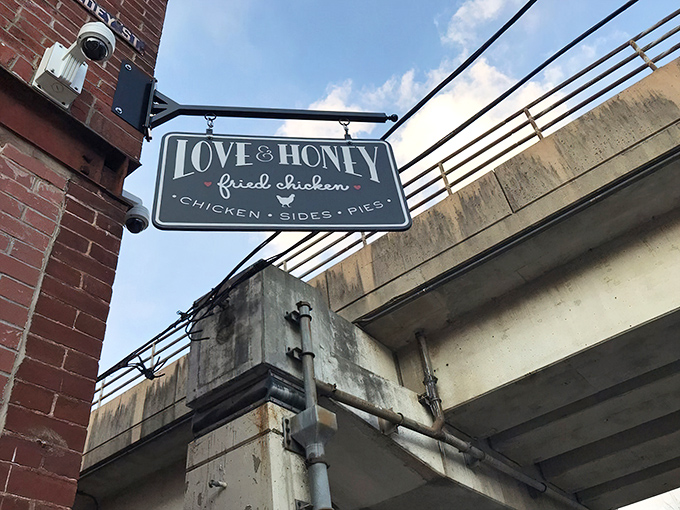Hanging proudly from the building's edge, this vintage-style sign serves as a beacon for fried chicken pilgrims wandering the streets of Northern Liberties.