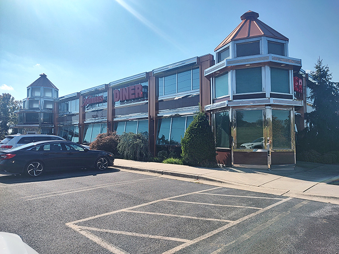 Sunlight bounces off the distinctive architectural features of this roadside gem, where hungry travelers have been finding solace for decades.