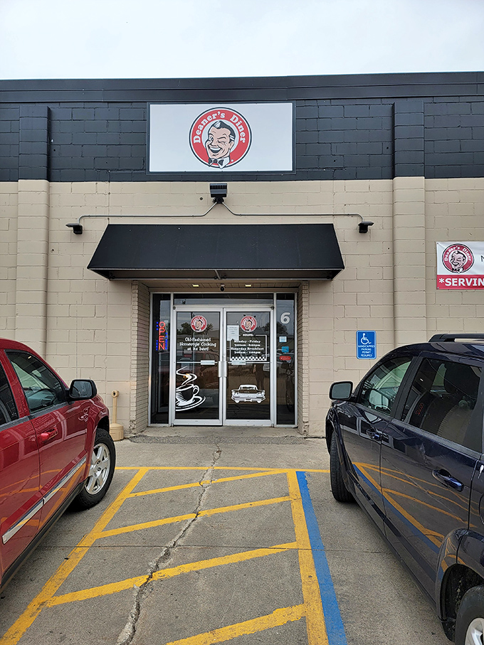 The unassuming exterior of Deaner's Diner proves once again that culinary treasures often hide behind the simplest facades. That cartoon face promises good things await inside!