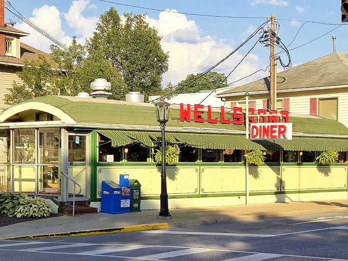The iconic green exterior of Wellsboro Diner stands proudly on Main Street, its vintage charm and bold red signage promising authentic Americana inside.
