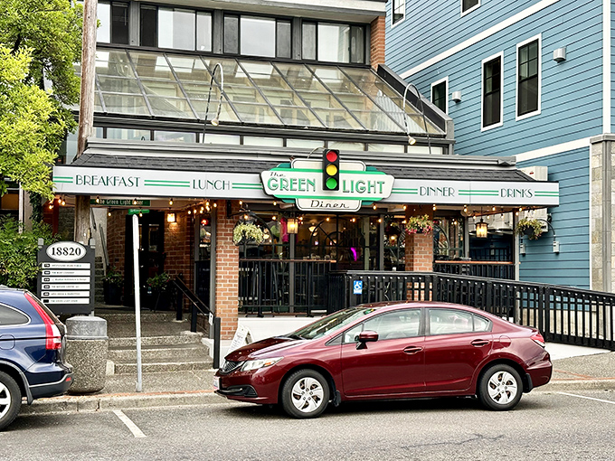 The Green Light Diner's iconic storefront beckons like a culinary lighthouse, promising comfort food treasures in downtown Poulsbo.