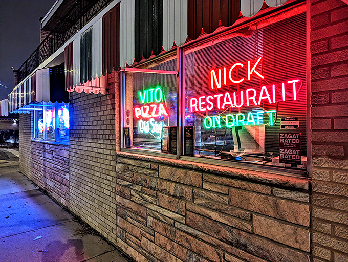The iconic neon glow of Vito & Nick's beckons hungry travelers like a South Side lighthouse of legendary Italian beef and pizza.