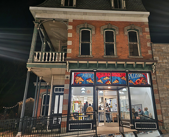 The historic brick fa&ccedil;ade of John's Wildwood Pizzeria glows like a beacon in the night, promising comfort food that transcends its humble appearance.