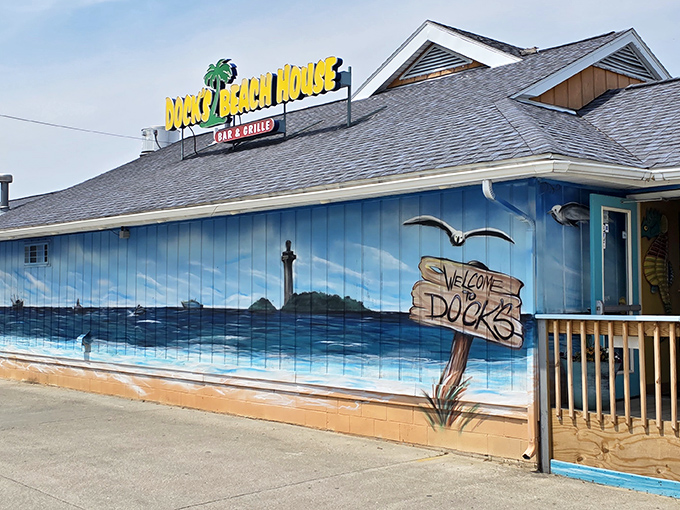 The bright blue exterior of Dock's Beach House welcomes hungry travelers with its cheerful palm tree sign and hand-painted ocean mural&mdash;vacation vibes in the heartland.