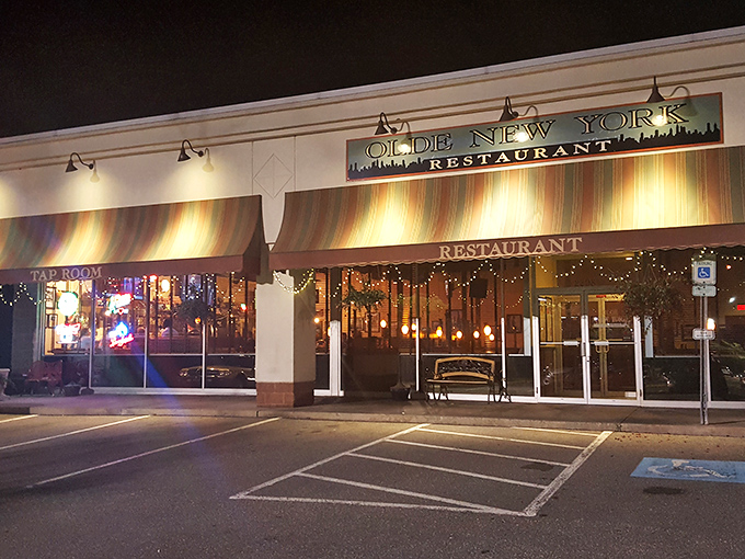 The welcoming glow of Olde New York's exterior beckons hungry travelers like a lighthouse for the stomach-starved. Those golden awnings promise comfort food salvation ahead.