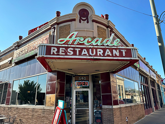 The iconic corner entrance of The Arcade Restaurant stands as Memphis's time machine to tastier days, its vintage neon sign beckoning hungry travelers since 1919.