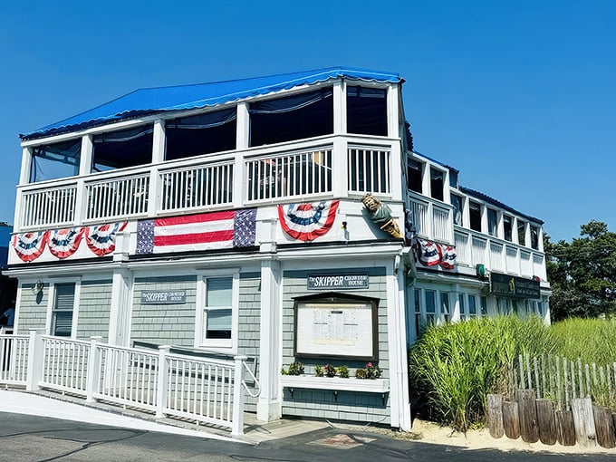 The Skipper's patriotic summer dress code: American flags, white railings, and the promise of seafood that makes you salute with your fork.