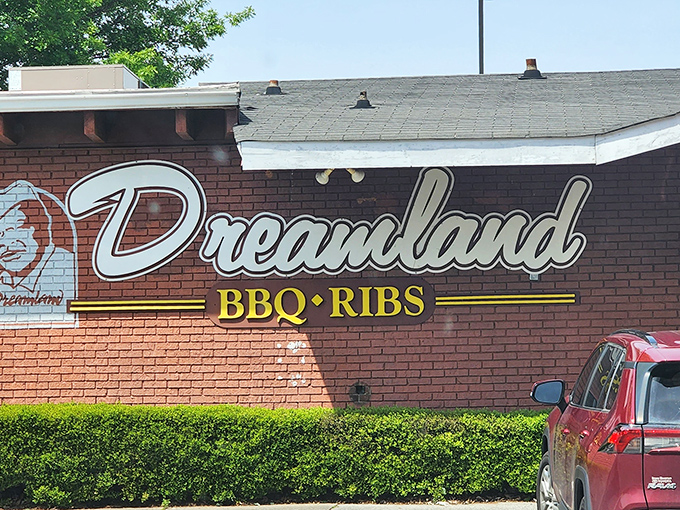 The brick exterior of Dreamland BBQ promises smoky treasures within, like a barbecue beacon calling hungry souls home.