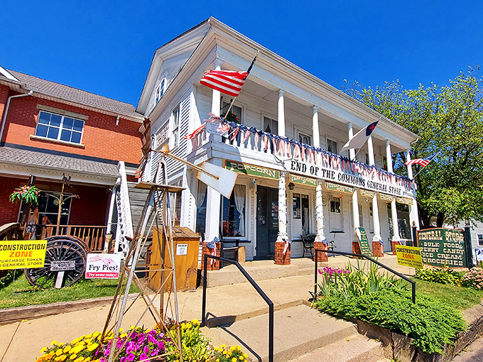 The white clapboard fa&ccedil;ade of End of the Commons General Store stands proudly against a blue Ohio sky, American flags fluttering like a welcome committee.