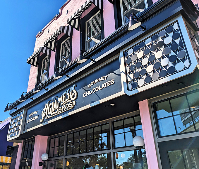 The pink palace of Oakley beckons with its vintage charm. Aglamesis Bros' distinctive fa&ccedil;ade promises sweet treasures within, standing proudly against the Cincinnati sky.