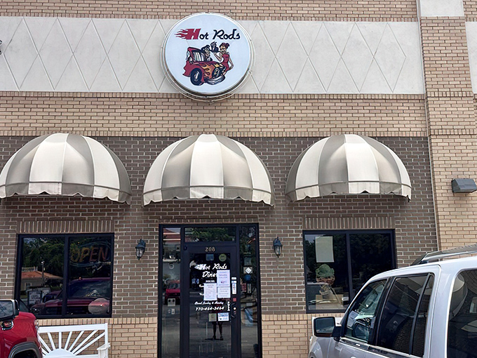 Classic Americana beckons from the roadside with those iconic red and white awnings—like a time machine disguised as a brick building.