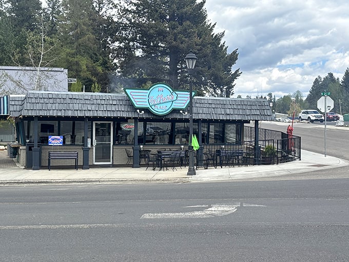 The iconic turquoise sign of My Father's Place stands out against McCall's mountain backdrop, promising burger perfection at this beloved corner establishment.