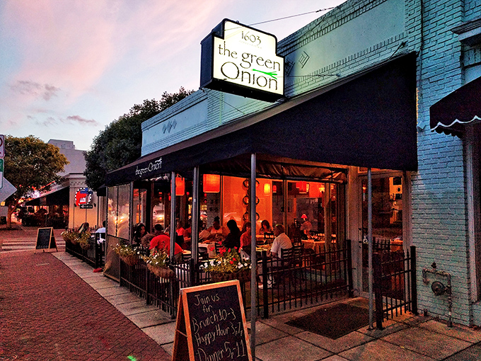 The twilight glow transforms this unassuming storefront into a beacon for hungry souls. Norfolk's Ghent neighborhood keeps this gem hidden in plain sight.