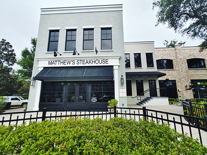 Matthew's Steakhouse stands proudly in Winter Garden, its elegant blue exterior and classic black awning promising culinary adventures within the charming historic downtown.