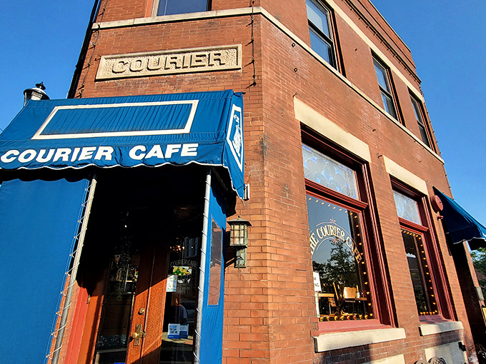 The entrance of The Courier Cafe on Race Street welcomes hungry travelers, its blue awning signaling a promise of breakfast salvation.